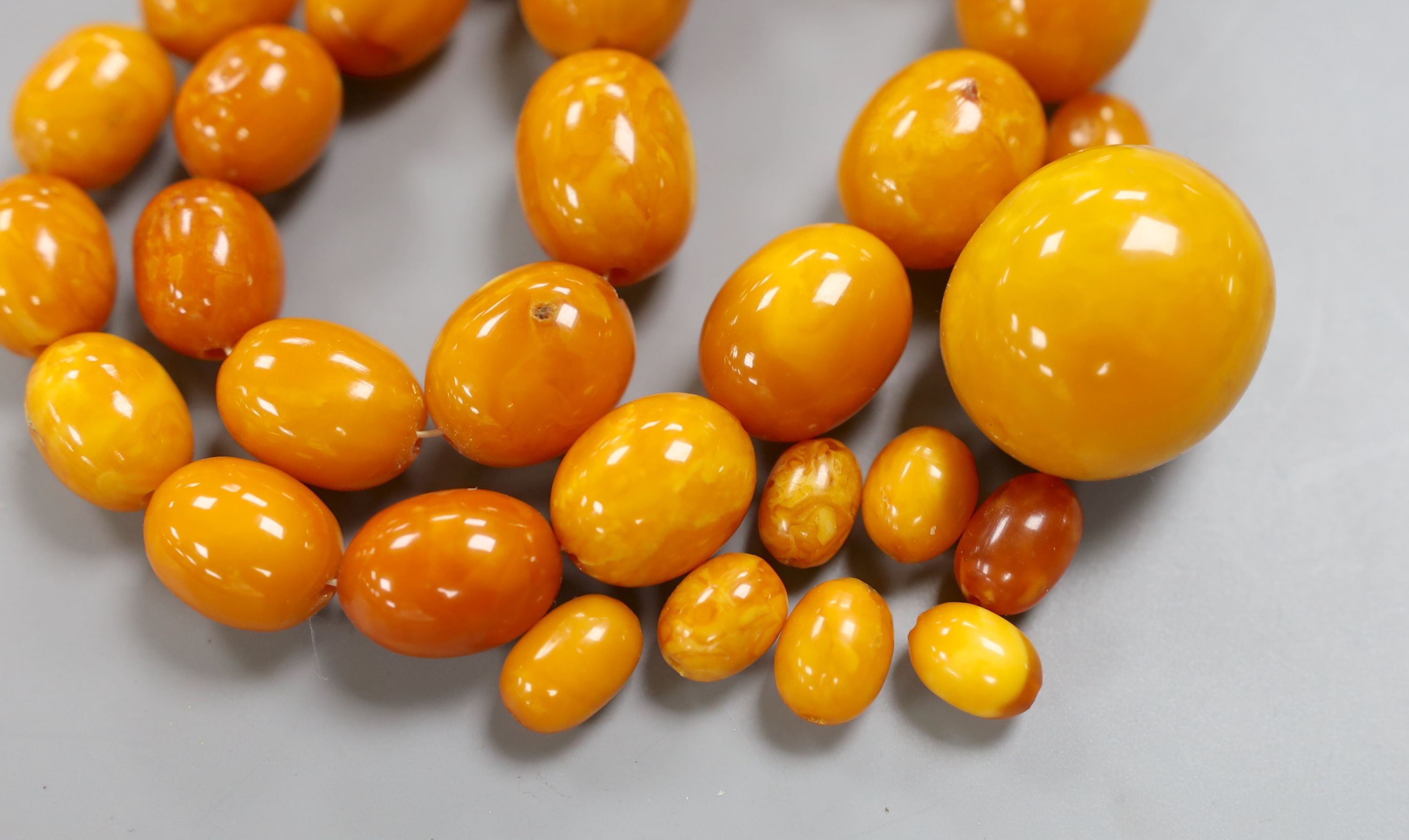 A single strand graduated oval amber bead necklace 43cm gross weight 51 grams and a few loose amber beads 16 grams. Sale 210222 Lot 913 Gorringe s
